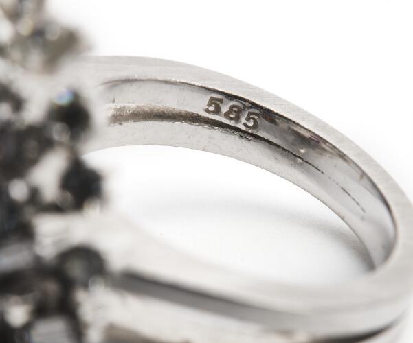 A ruby ring set with a Burma ruby encircled by numerous diamonds ...