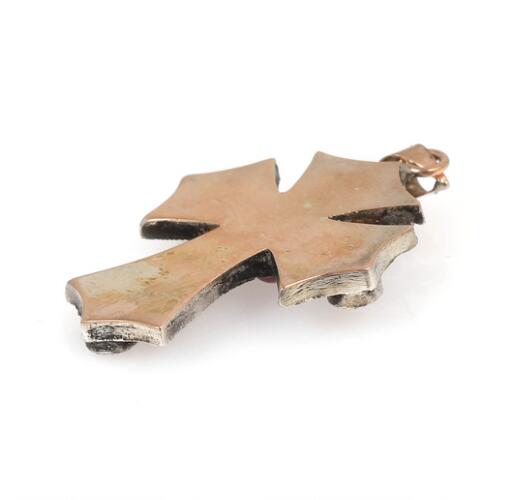 A ruby and diamond pendant in the shape of a cross set with numerous ...