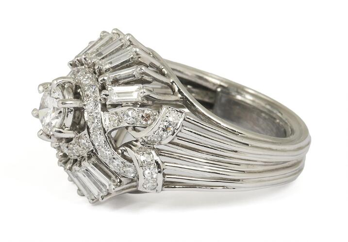 A diamond ring set with a brilliant-cut diamond encircled by numerous ...