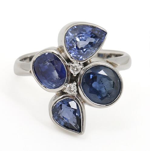 A sapphire and diamond ring set with four sapphires and two diamonds ...
