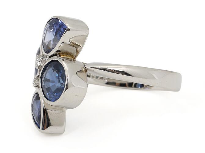 A sapphire and diamond ring set with four sapphires and two diamonds ...