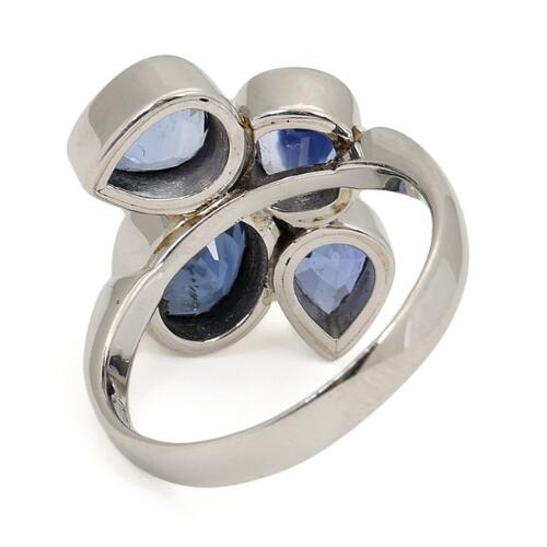 A sapphire and diamond ring set with four sapphires and two diamonds ...