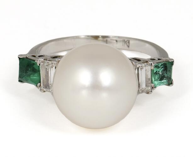 A pearl ring set with a South Sea cultured pearl flanked by diamonds ...