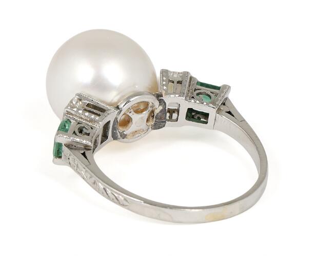 A pearl ring set with a South Sea cultured pearl flanked by diamonds ...