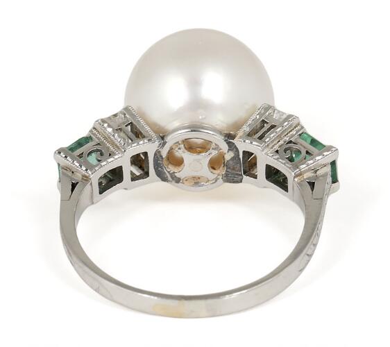 A pearl ring set with a South Sea cultured pearl flanked by diamonds ...