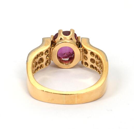 A ruby and diamond ring set with an oval-cut presumably Burma ruby ...